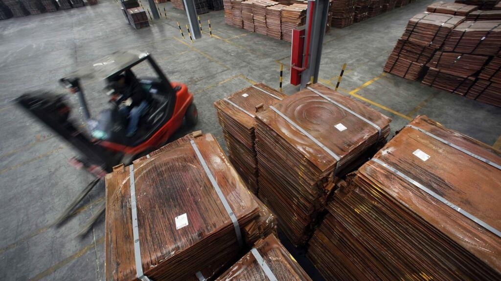 file picture shows a worker loading copper cathodes into a warehouse ...